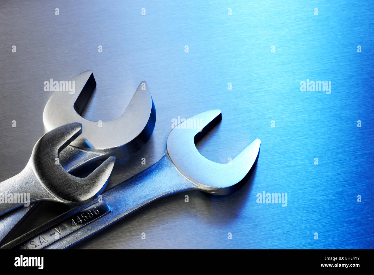 Wrenches on blue stainless background Stock Photo - Alamy