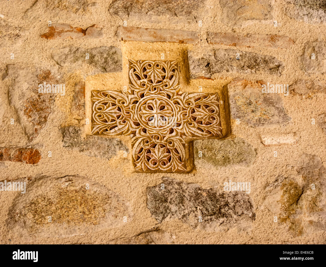 Ancient Greek cross on the stone wall. Background Stock Photo - Alamy