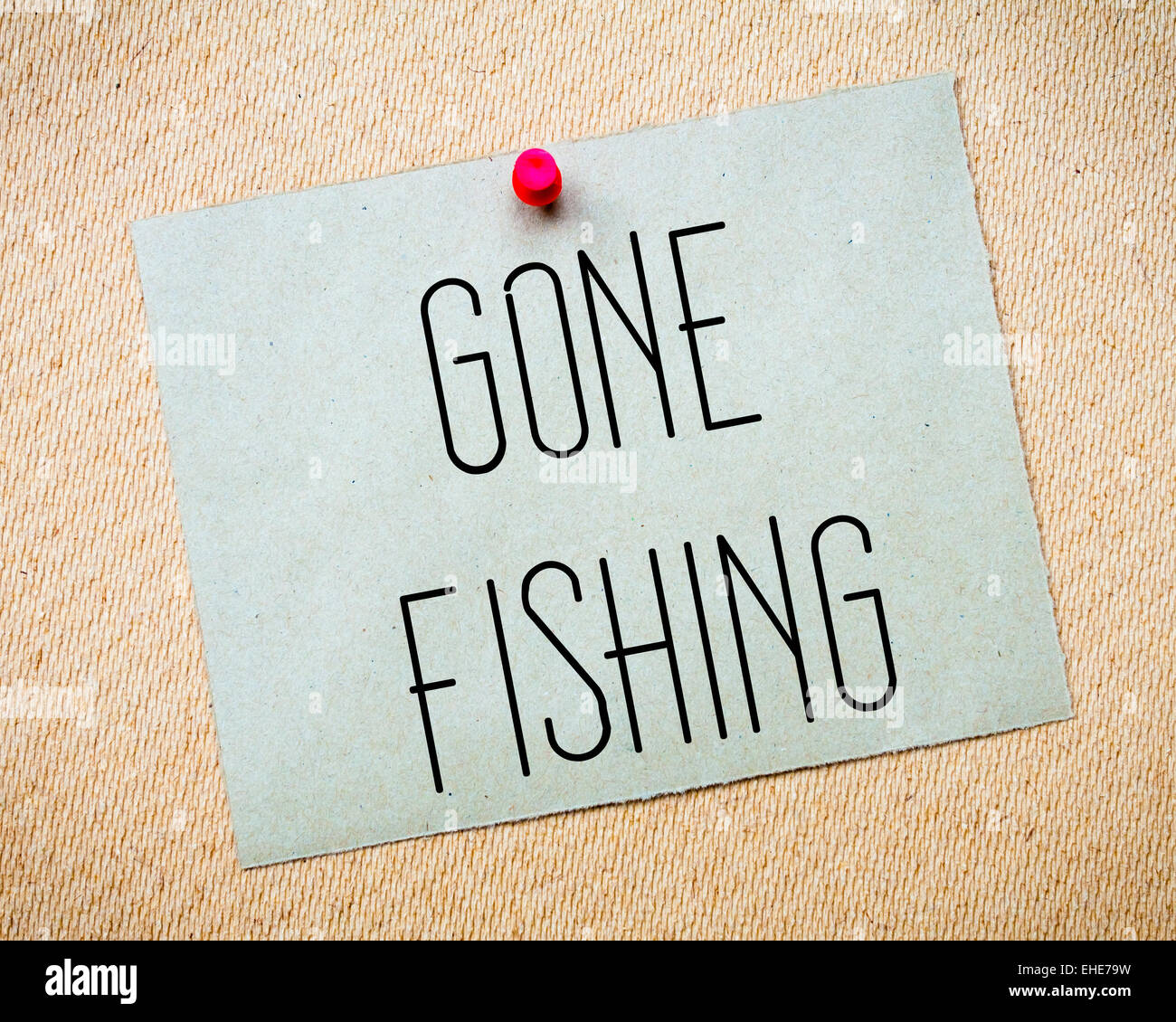Recycled paper note pinned on cork board. Gone Fishing Message. Concept ...