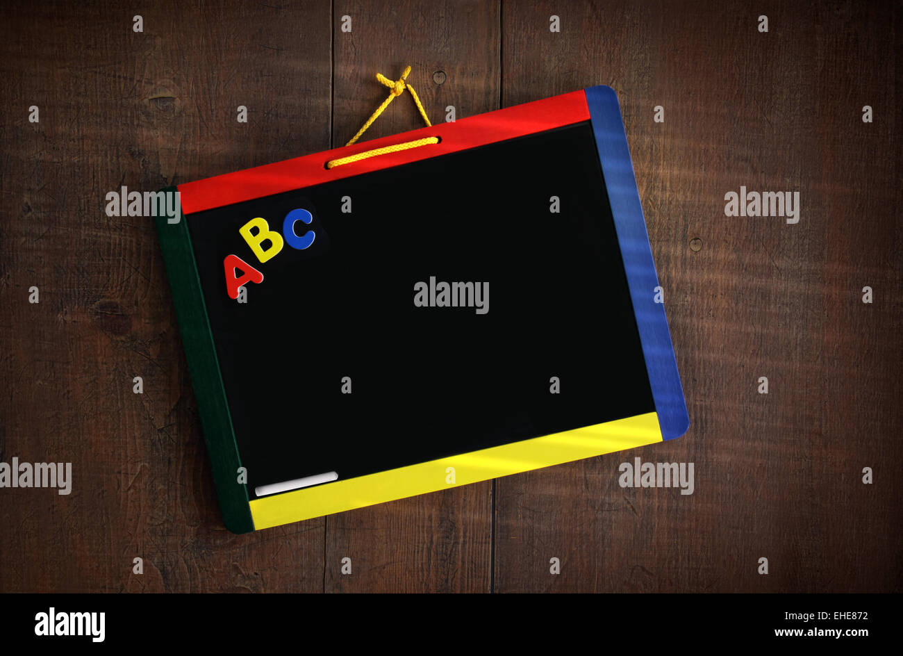 Child's chalkboard hanging against a wood Stock Photo - Alamy