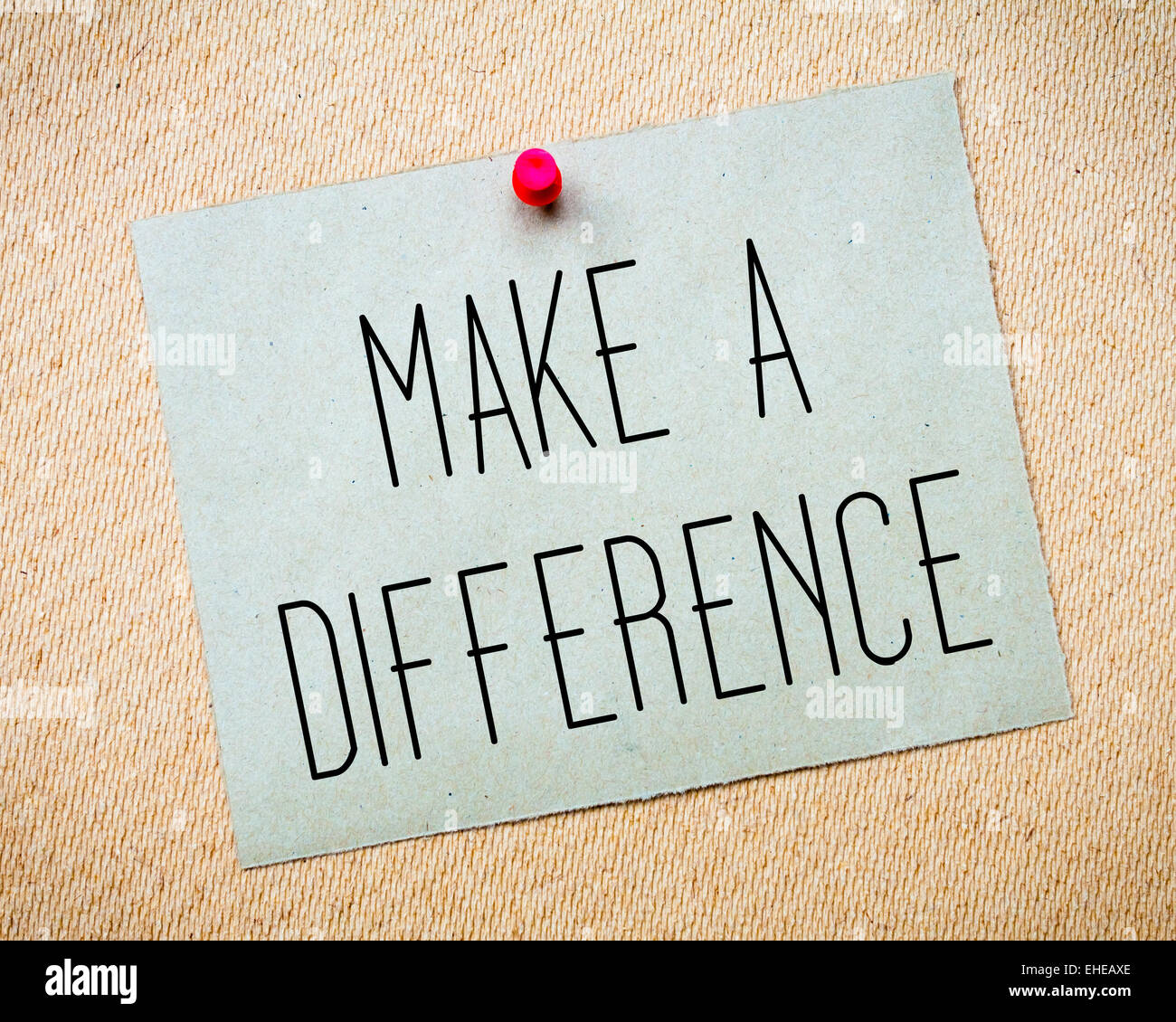 Recycled paper note pinned on cork board. Make a Difference Message ...