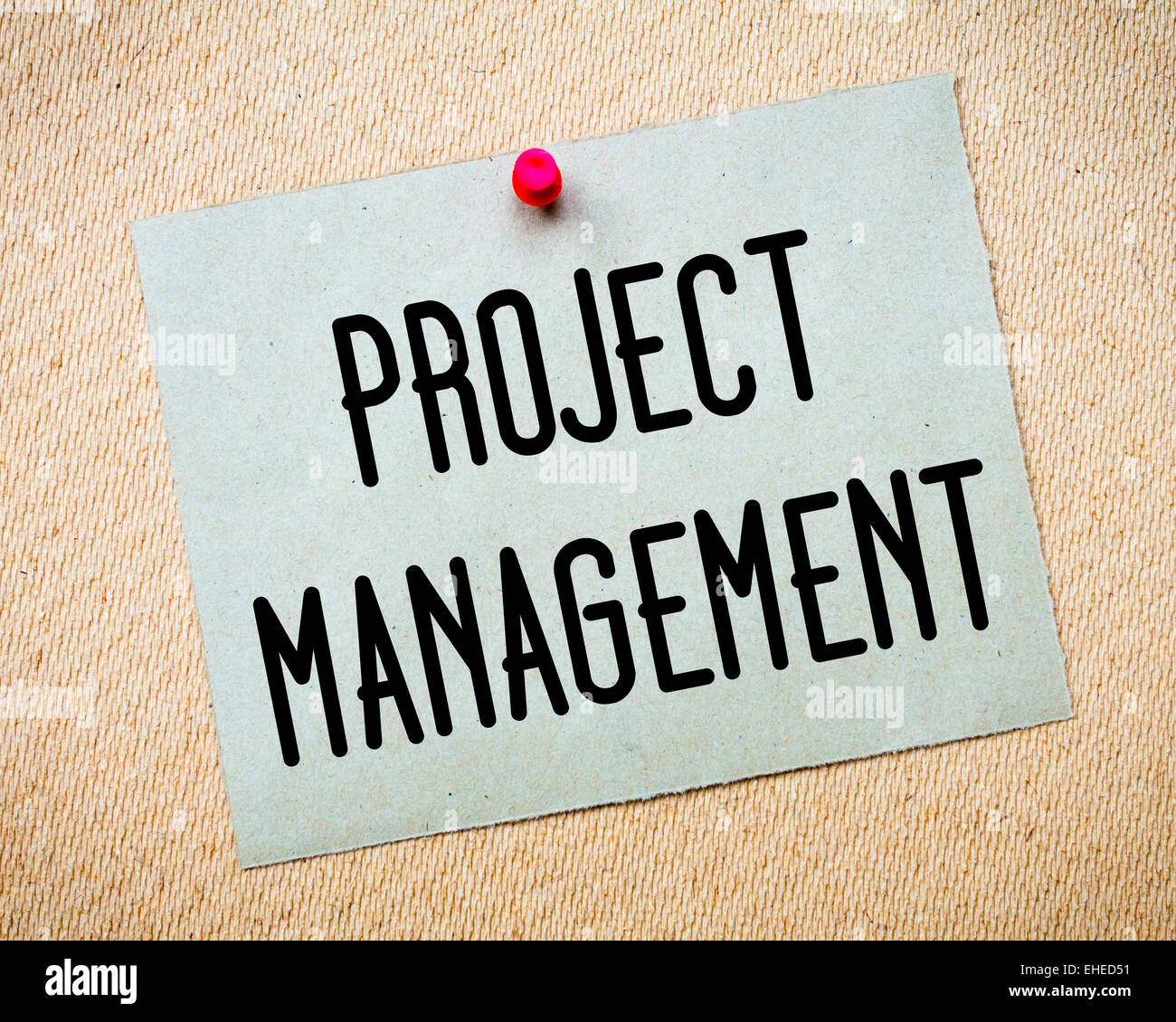 Recycled paper note pinned on cork board. Project Management Message ...