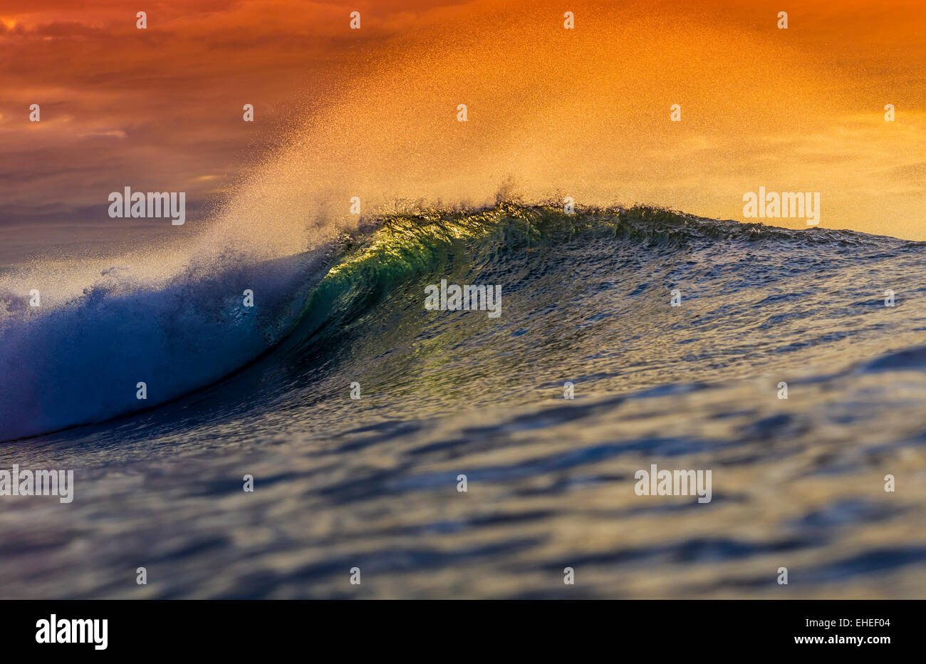 Colored Ocean Wave Falling Down at Sunset Time Stock Photo - Alamy