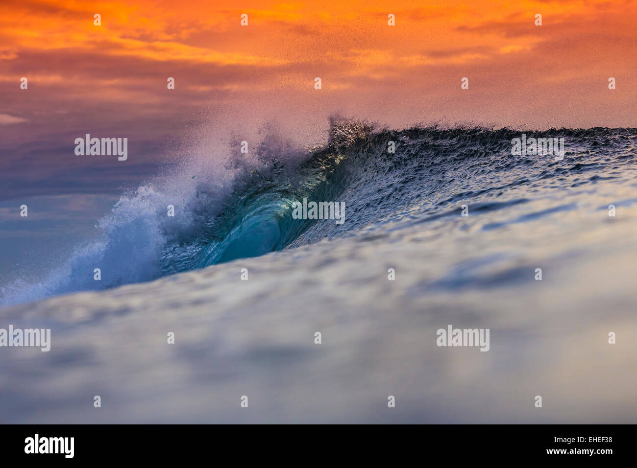 Colored Ocean Wave Falling Down at Sunset Time Stock Photo - Alamy