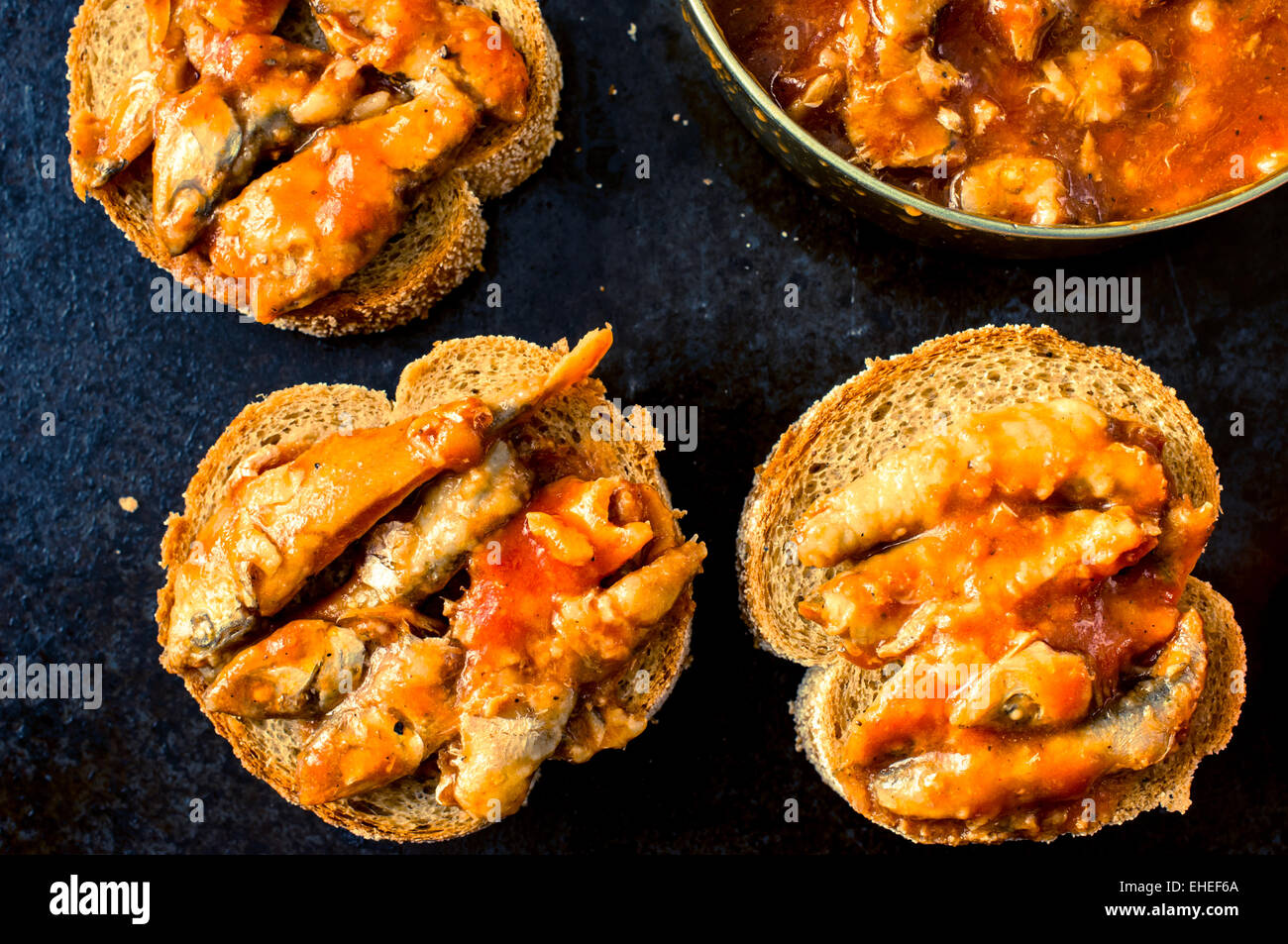 Tapas with canned fish in tomato sauce Stock Photo - Alamy