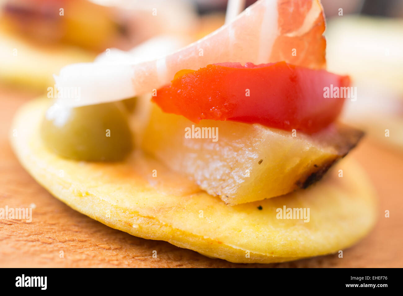 Tapas with bacon and potatoes, olives and tomatoes Stock Photo - Alamy