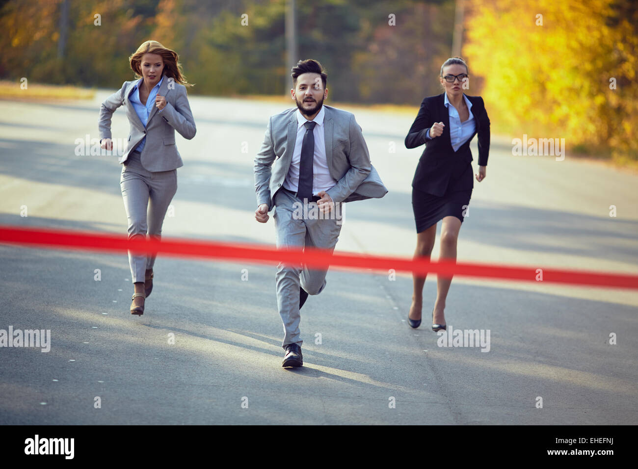 Businessman competing with two businesswomen Stock Photo - Alamy