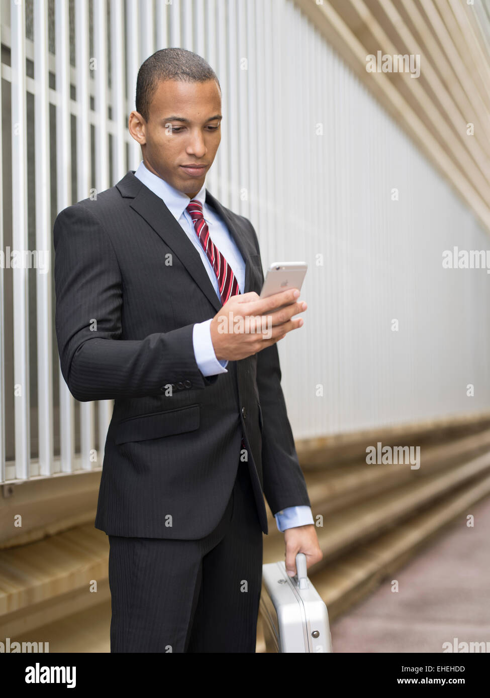 Businessman using Apple iphone Stock Photo - Alamy