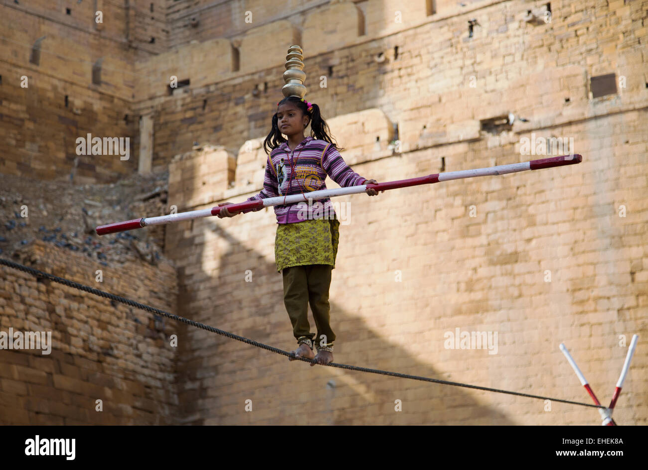 A female acrobat performs at the entrance to the Fort at Jaisalmer ...