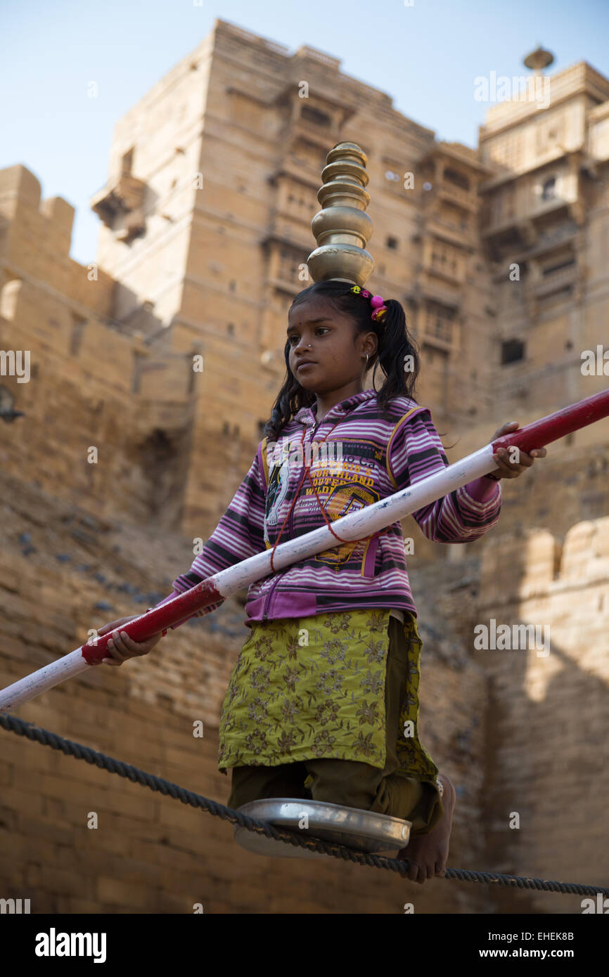 A female acrobat performs at the entrance to the Fort at Jaisalmer ...