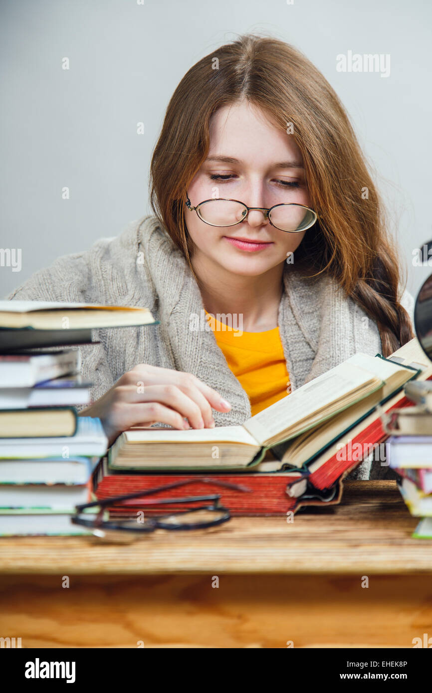 girl student with glasses reading books Stock Photo - Alamy