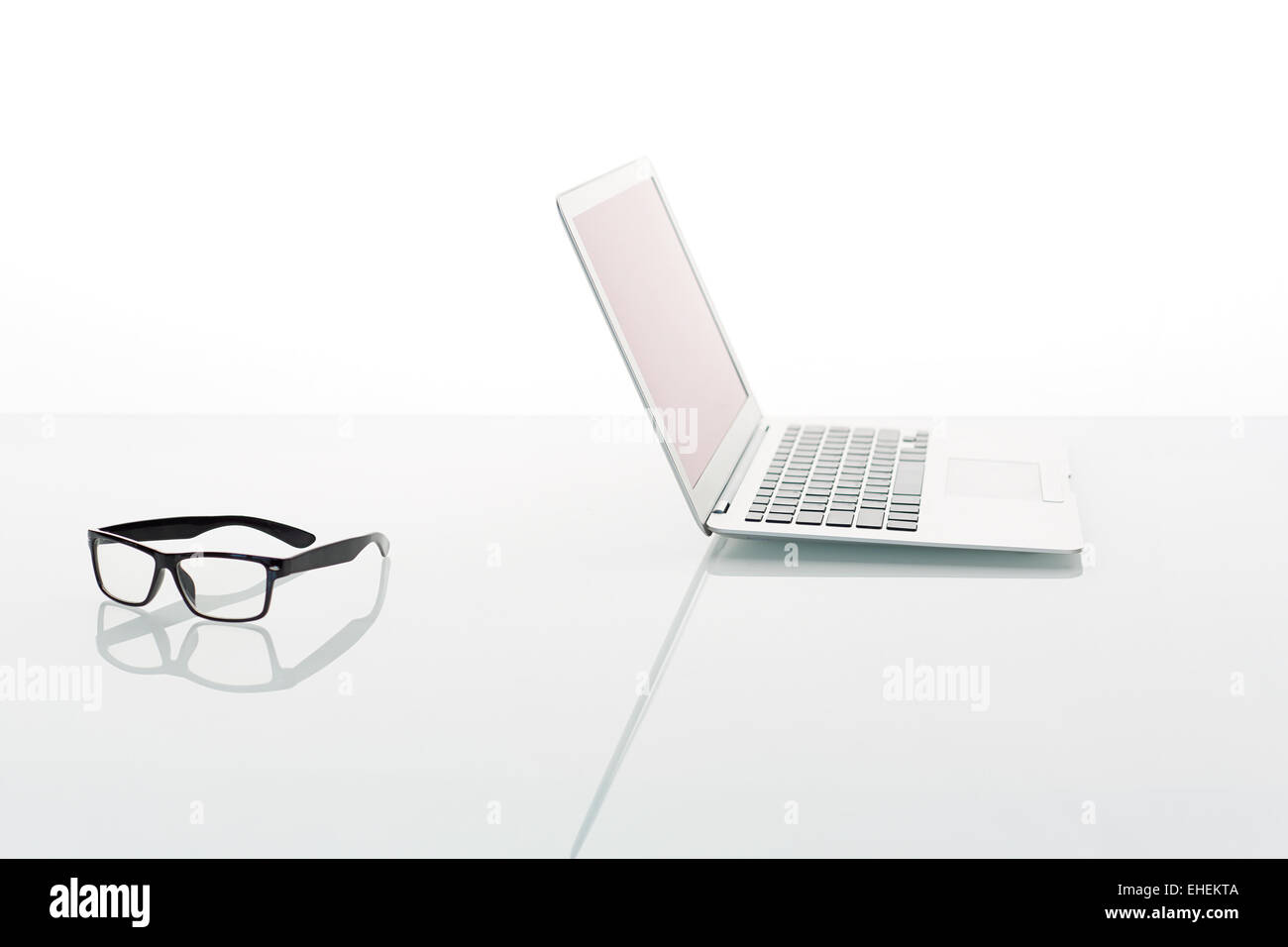 Laptop and glasses isolated on white Stock Photo - Alamy