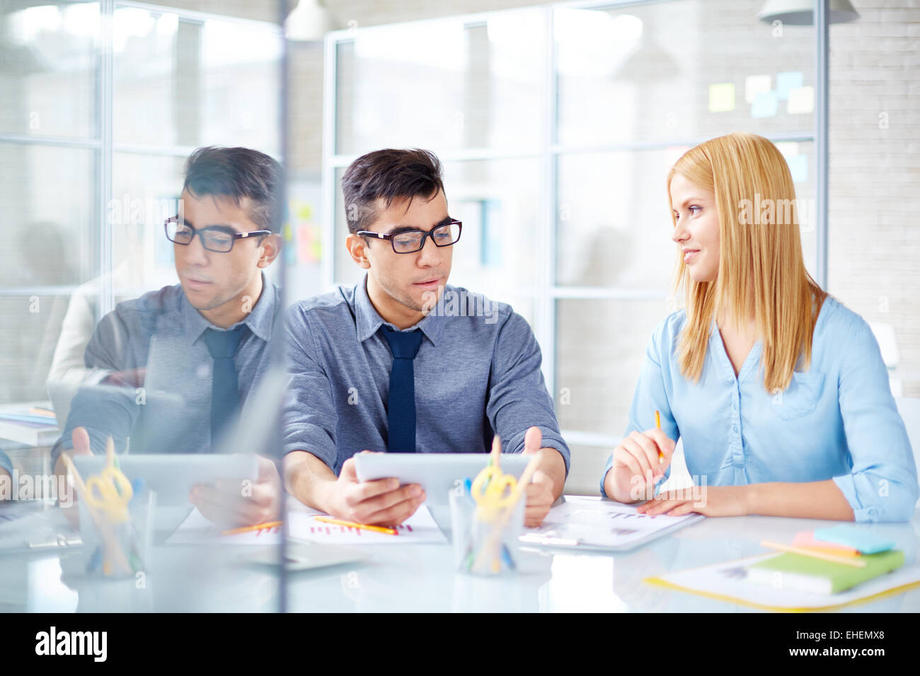 Two workers talking in office Stock Photo - Alamy