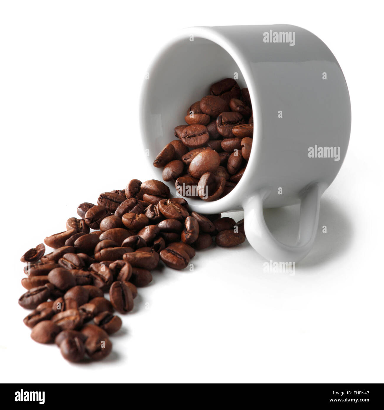 Spilled coffee beans from the cup isolated on white background Stock ...