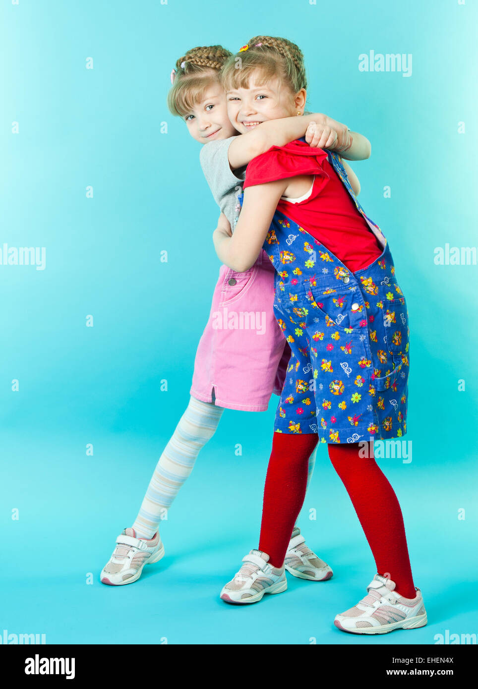 Twin sisters hugging Stock Photo - Alamy