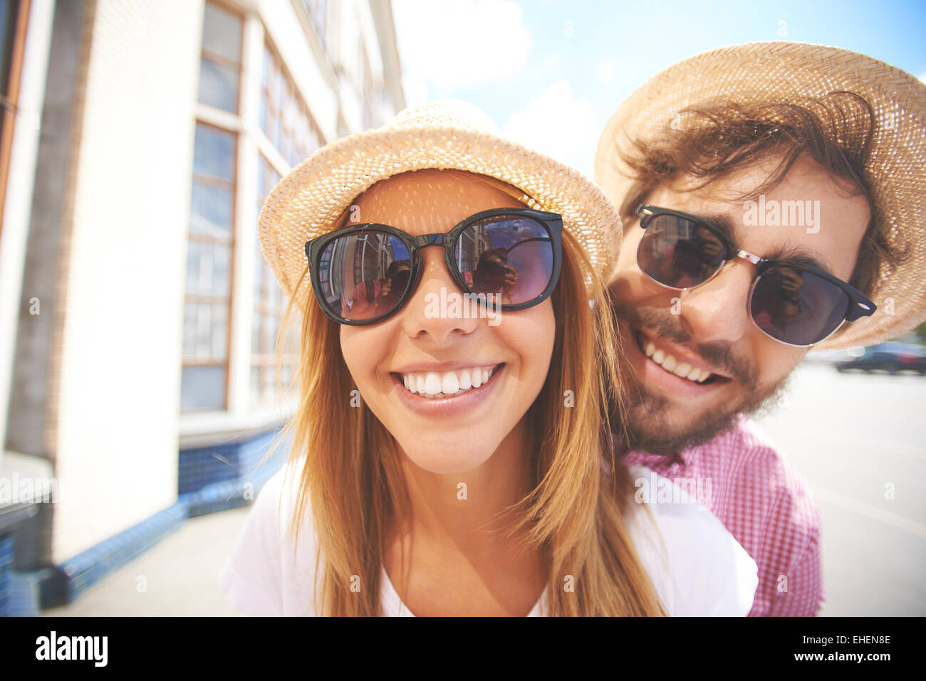 Cheerful faces of young couple Stock Photo - Alamy