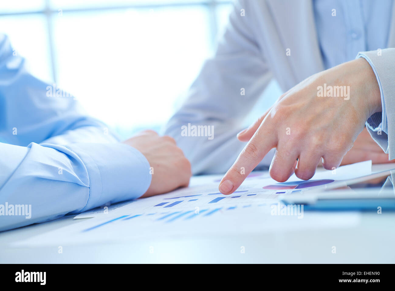 Male colleague pointing documents female hi-res stock photography and ...