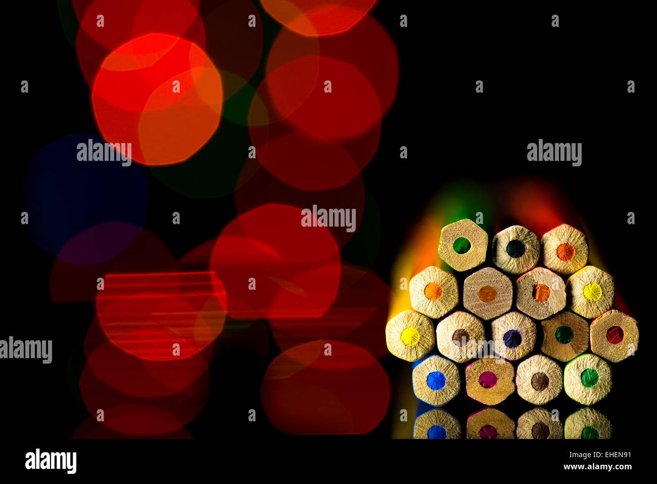 Color pencils with black background an bokeh Stock Photo - Alamy