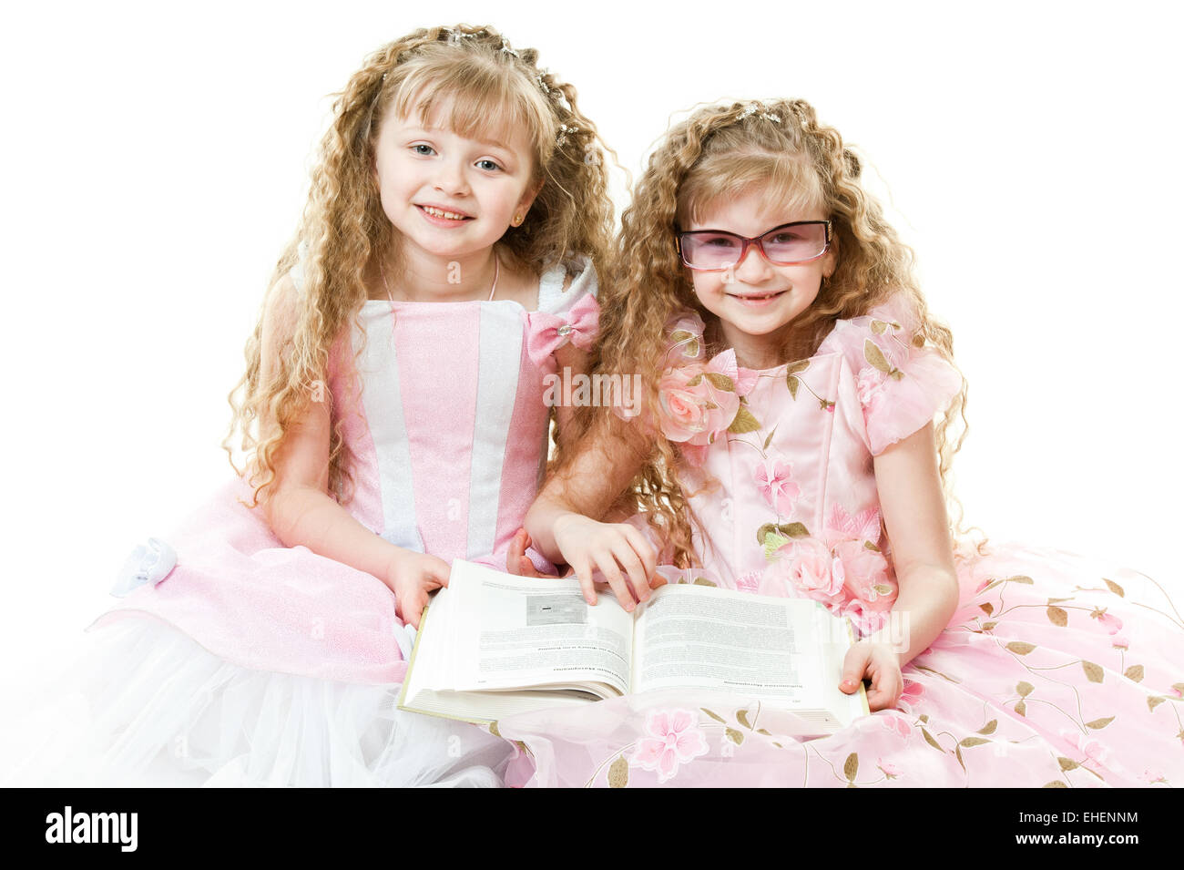 Twin princesses reading a book Stock Photo - Alamy