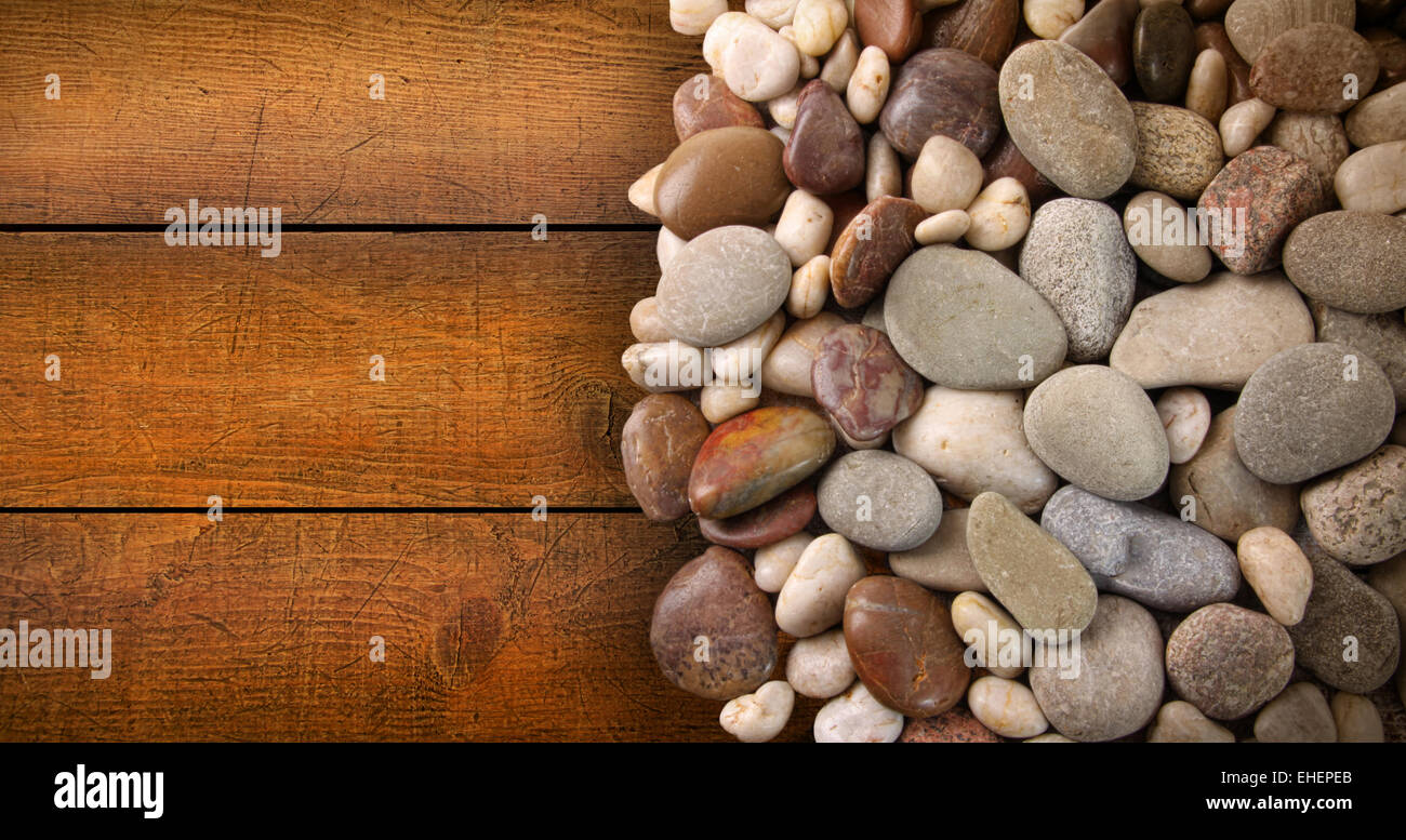 Colorful river stones on a wood Stock Photo - Alamy