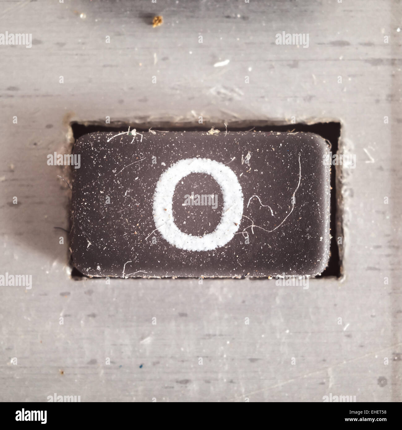 Old dirty and dusty rubberized button with written number on it, part ...