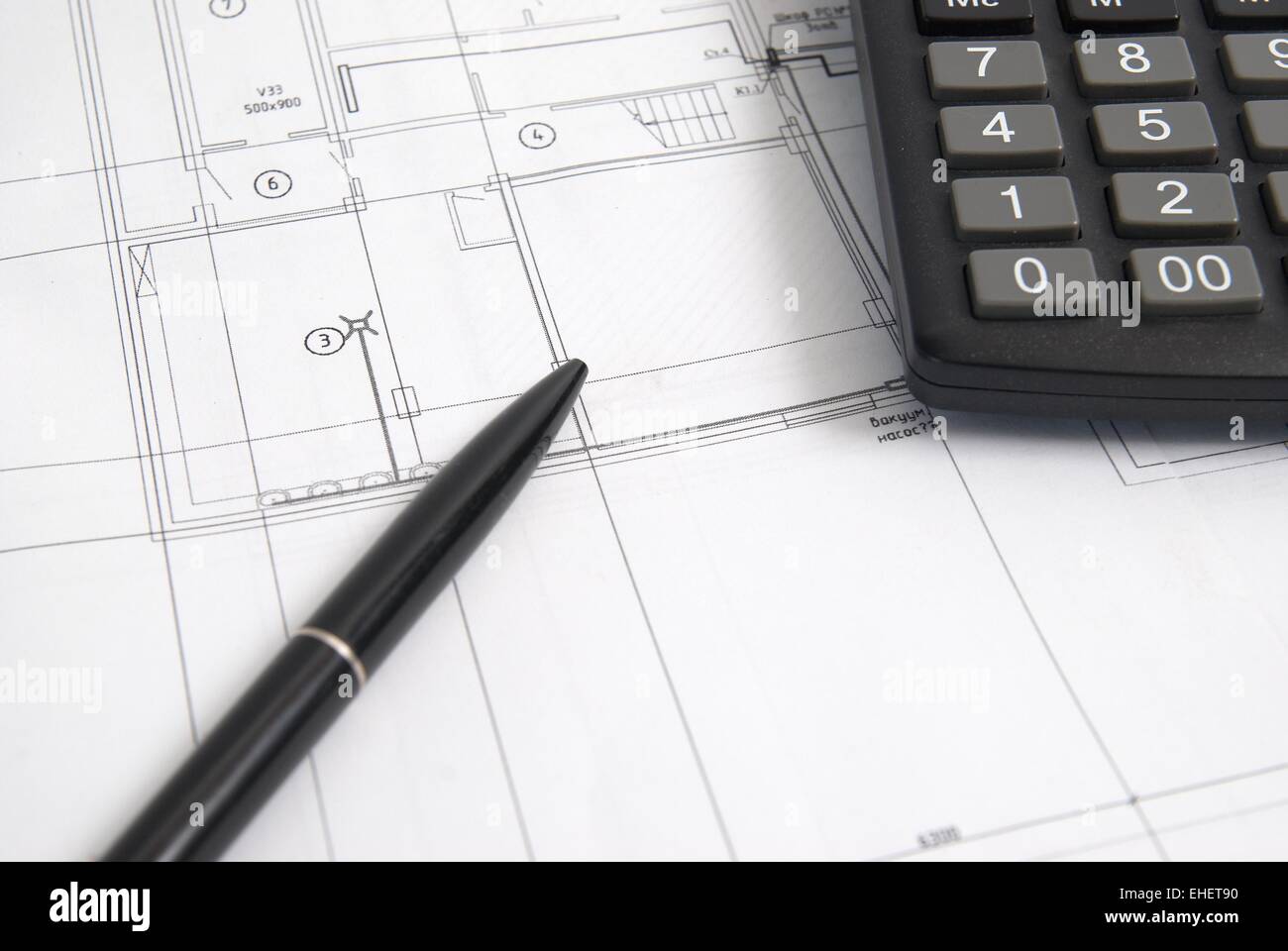 Calculator and pen on the drawing Stock Photo - Alamy