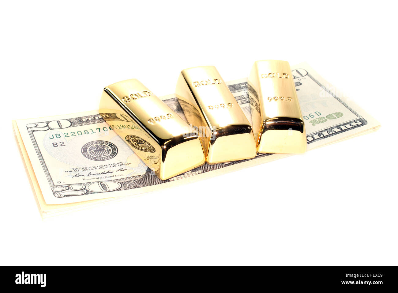 three gold bars on dollar bills Stock Photo - Alamy