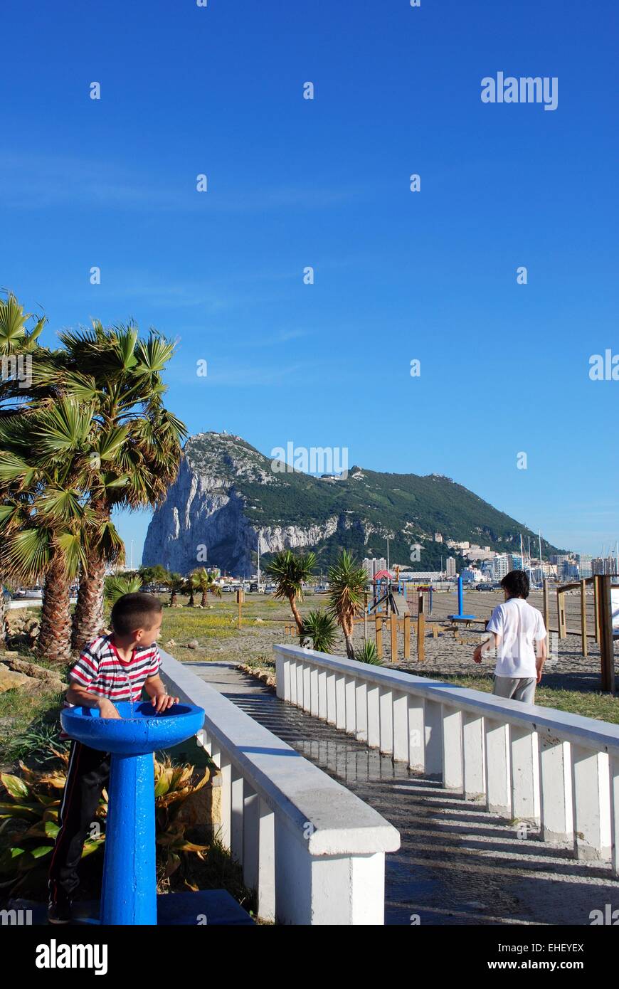 Boy taking a drink from a drinking fountain on La Linea beach in Spain ...