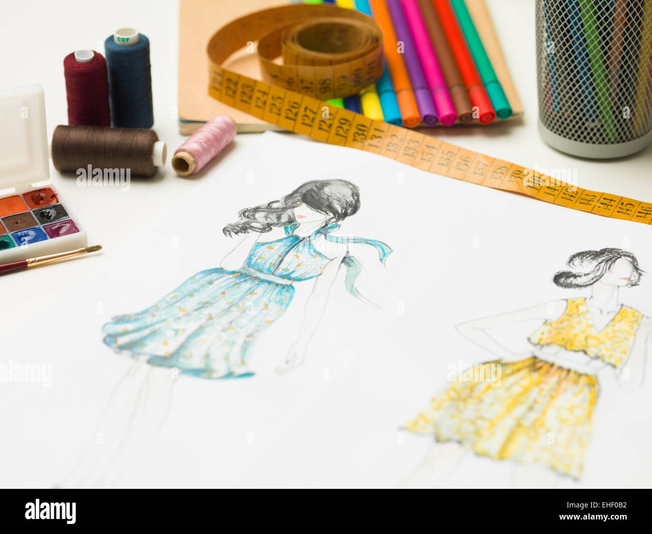 closeup of fashion designer workspace with sketches and designing ...
