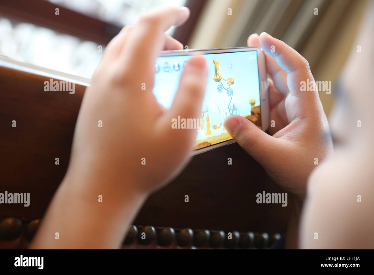 The boys to use mobile phone to play games Stock Photo - Alamy