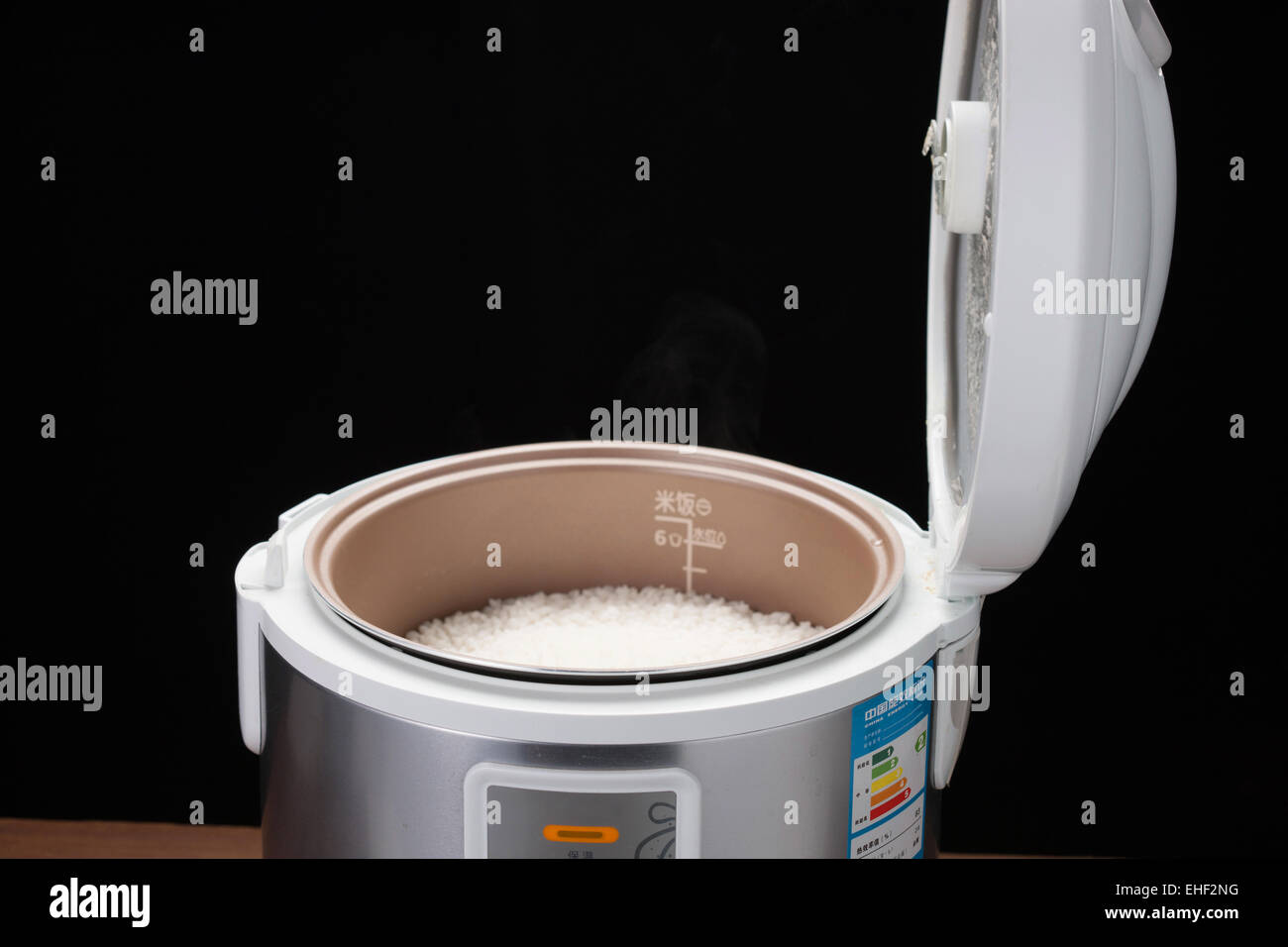 Electric rice cooker cooking Stock Photo - Alamy