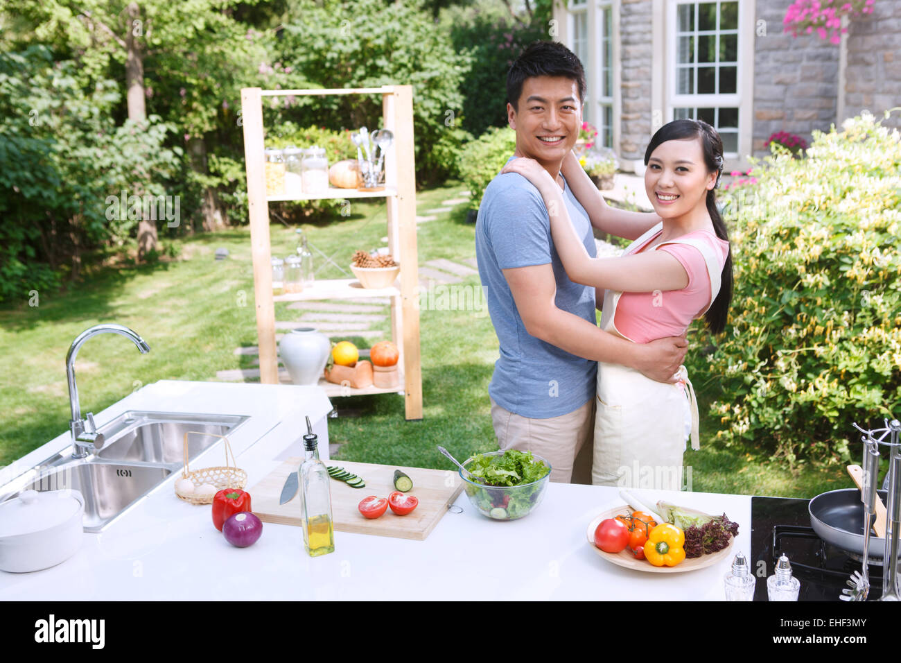 The young couple outside the kitchen Stock Photo - Alamy