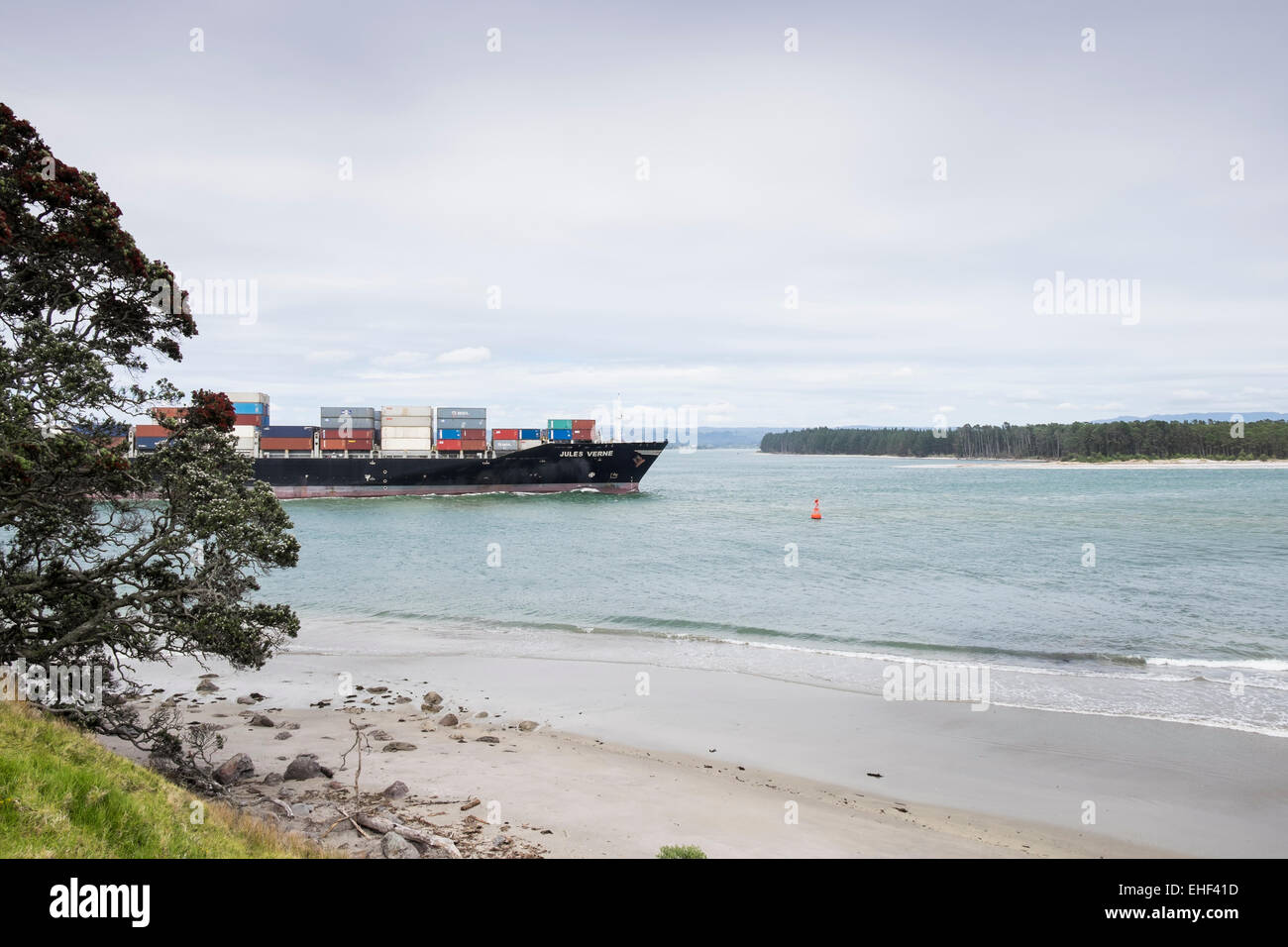 Container ship seen from the coast around the base of Mauoa mountain in ...