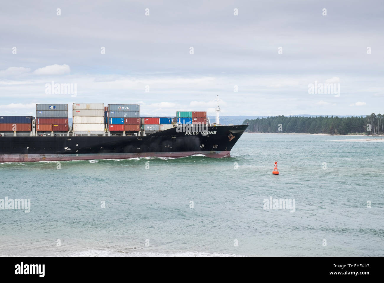 Container ship seen from the coast around the base of Mauoa mountain in ...