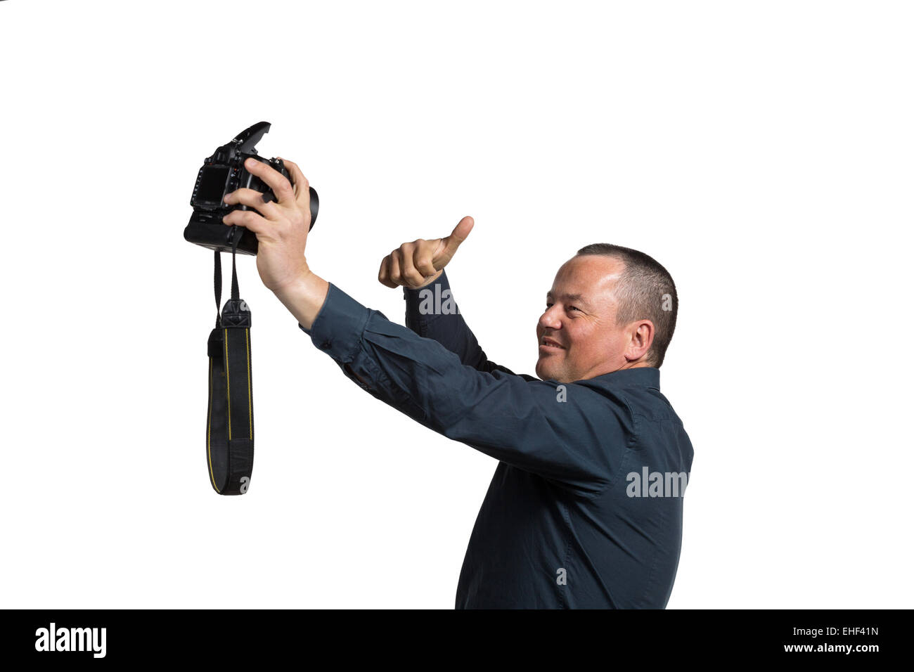 Guy in his 40s fooling around with too big a camera for a selfie Stock ...