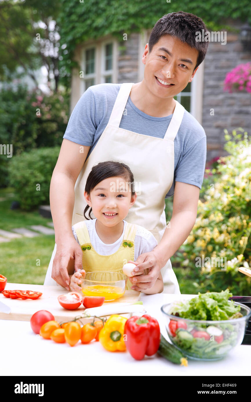 Father and daughter to prepare food in the outdoor kitchen Stock Photo ...