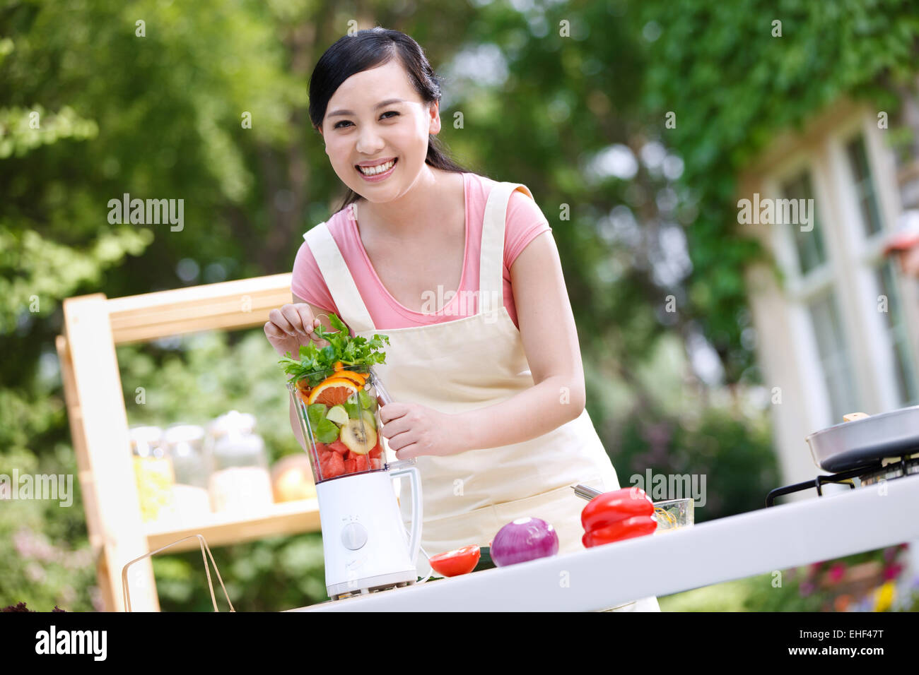 Oriental woman holding blender hi-res stock photography and images - Alamy