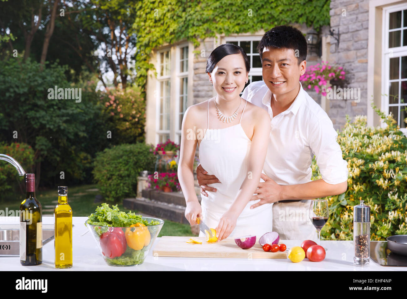 The young couple cook in the outdoor kitchen Stock Photo - Alamy