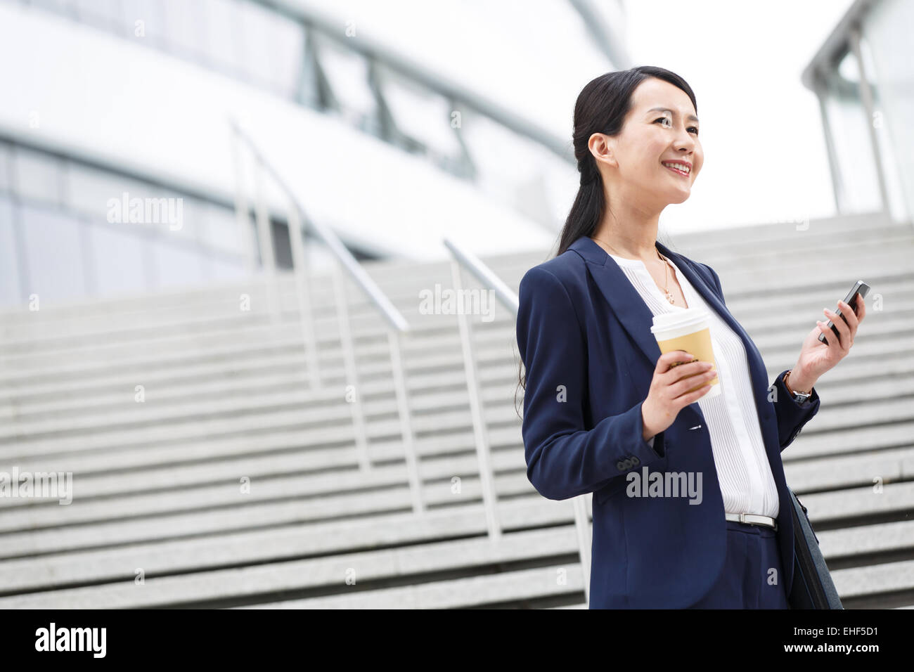 Successful business women carrying Coffee cup Stock Photo - Alamy