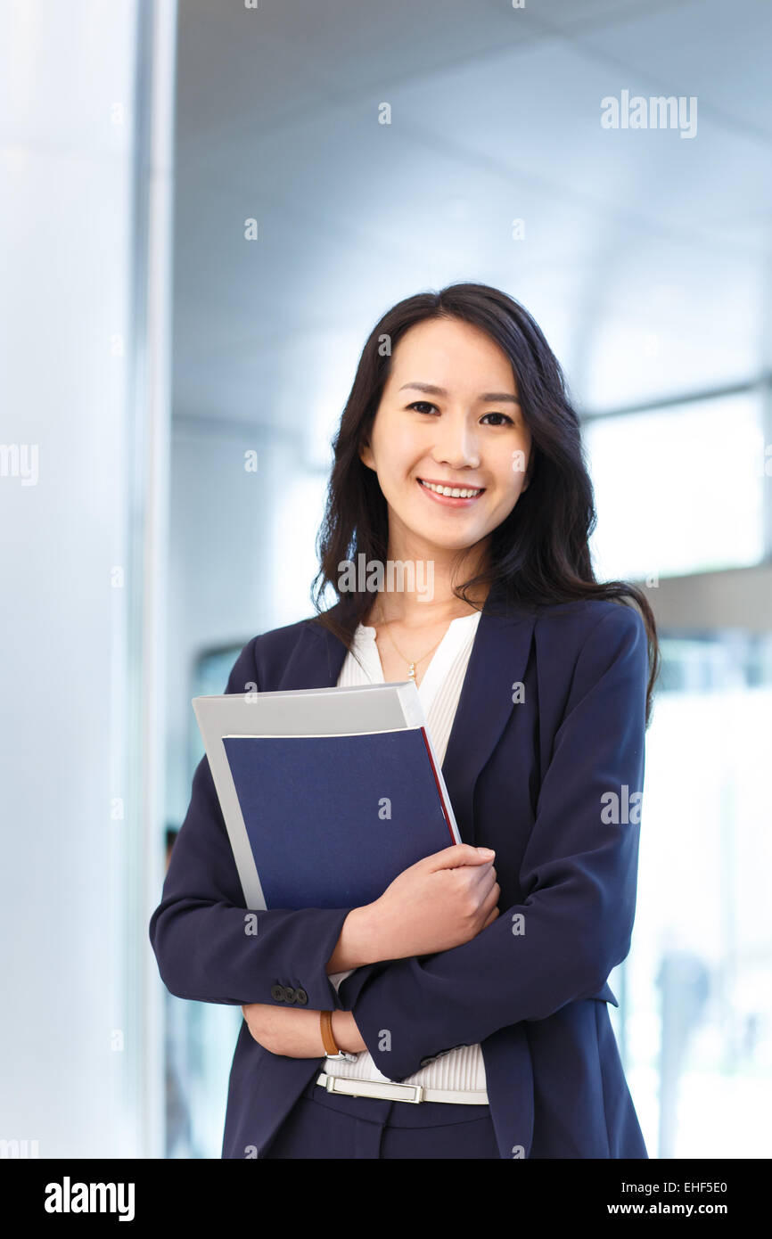 Successful business women holding company documents Stock Photo - Alamy