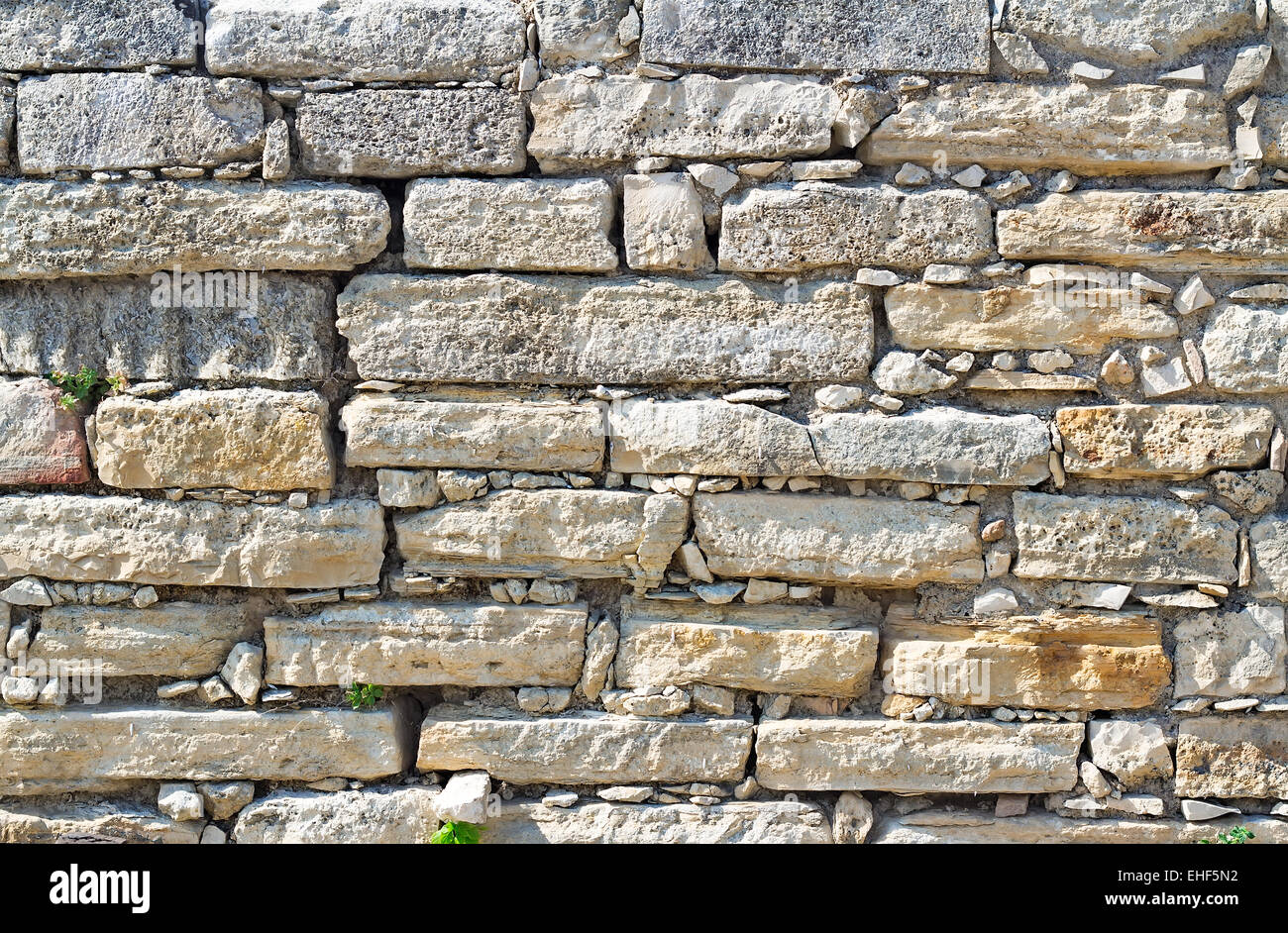 Fragment of the ancient stone wall executed from stones of various form ...