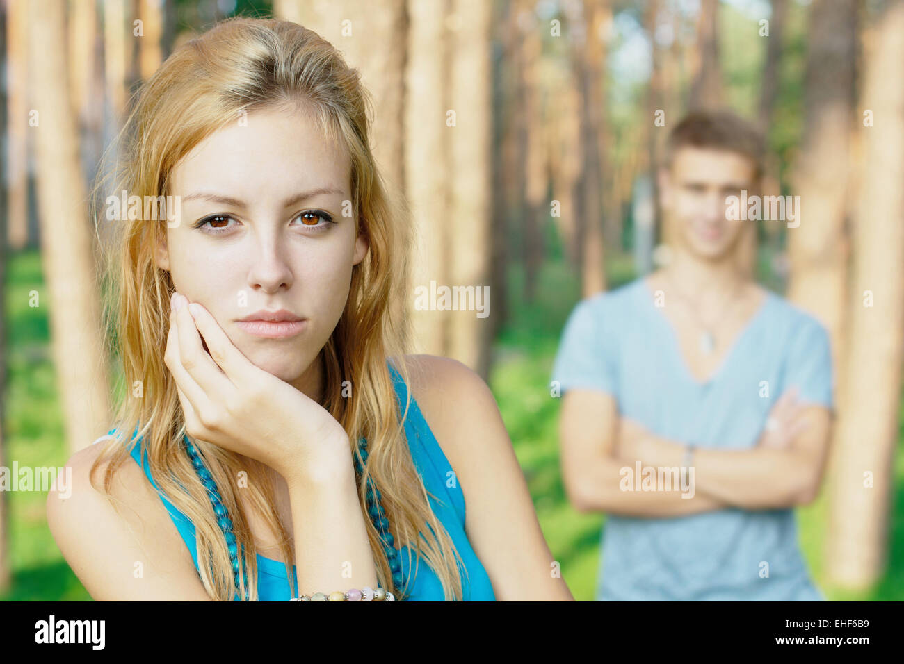 Offended girl and a boy at the background Stock Photo - Alamy