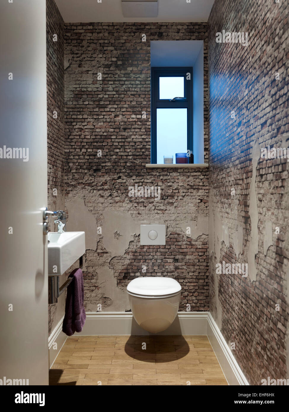 Faux bare brick walled toilet of The Organ Factory home, UK Stock Photo ...