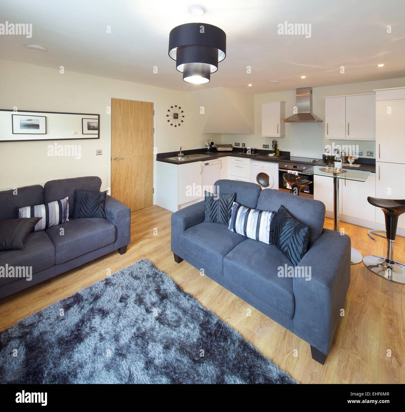 Modern open plan room with kitchen and sitting area in apartment at ...