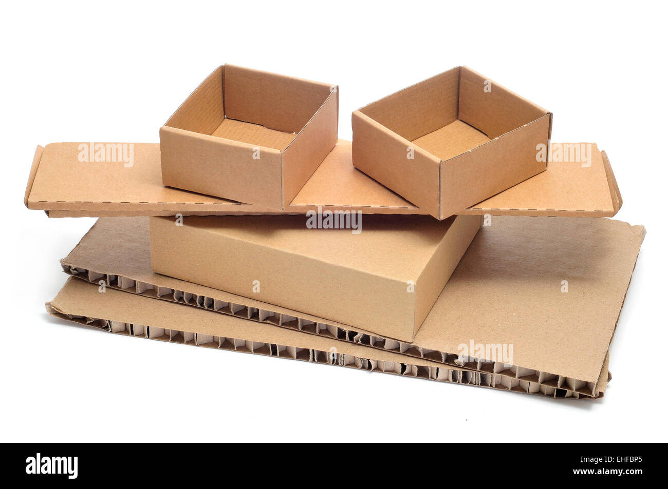 some brown cardboard boxes of different sizes and some pieces of ...