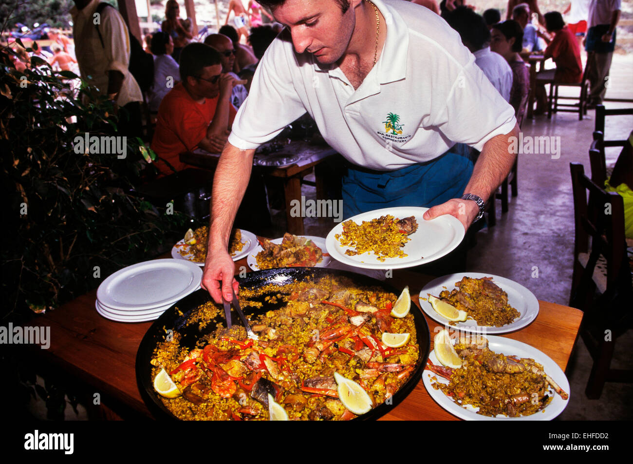 Man serving paella at Tanga restaurant on Formentera near Ibiza Spain ...