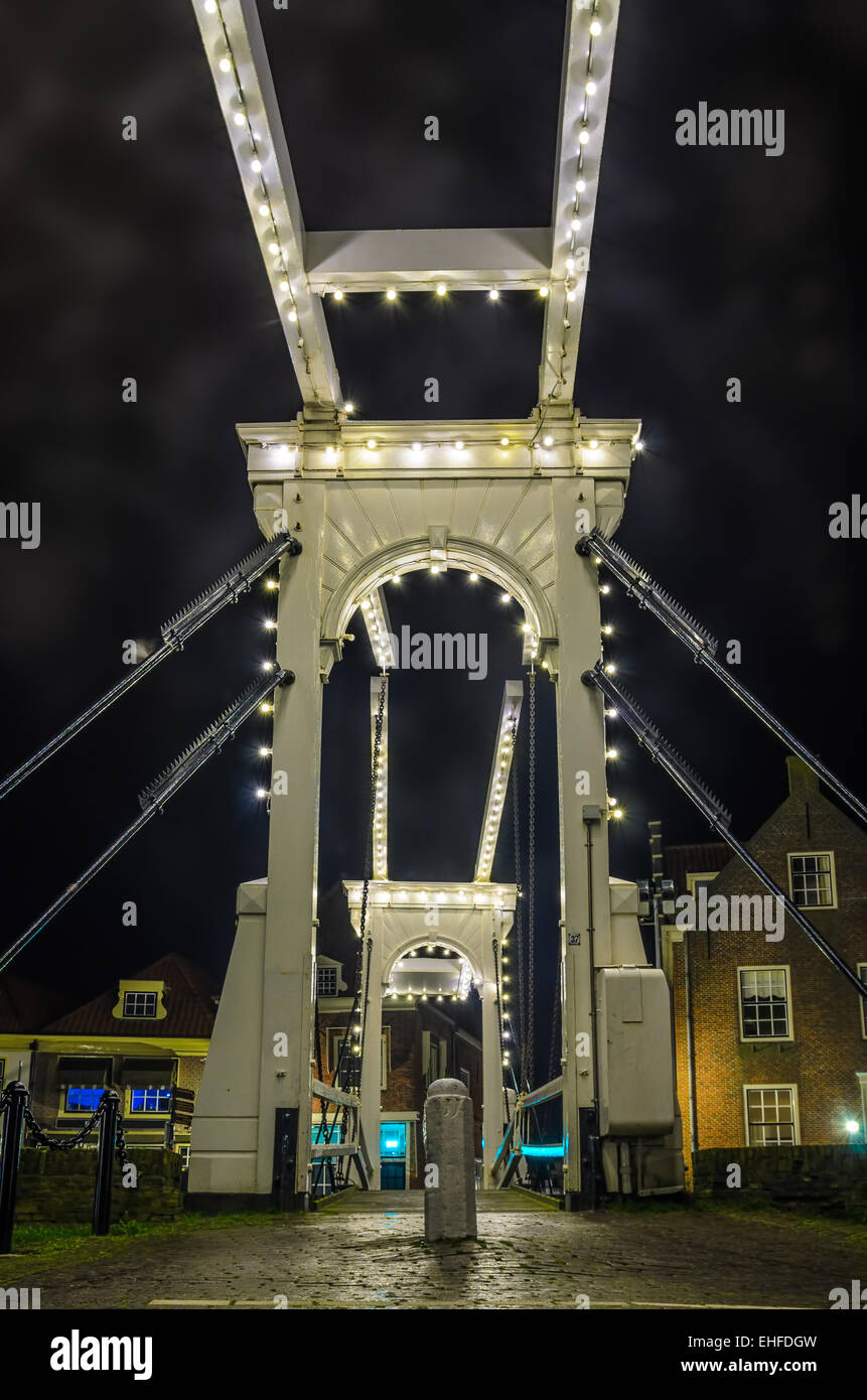 Old small drawbridge over the canal at night with cloudy sky, Enkhuizen ...