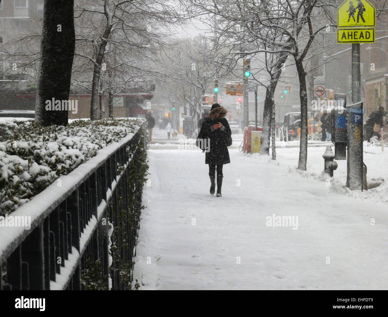 Pedestrians trudge through the snow on their way to work in the Chelsea ...