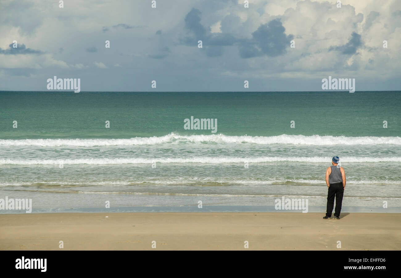 Man looking out to sea Stock Photo - Alamy
