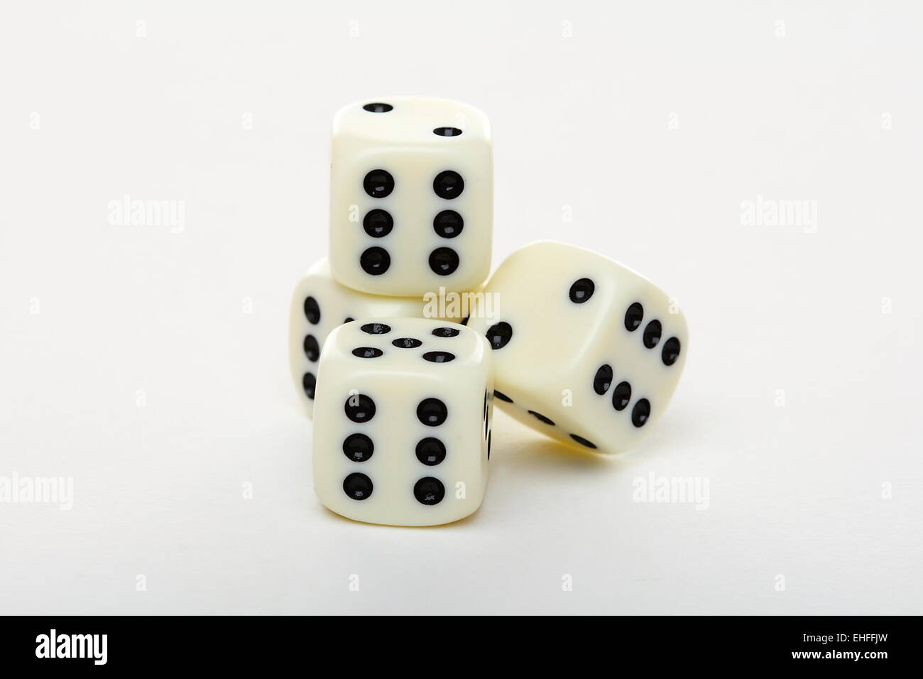 Four dice on a white background Stock Photo - Alamy